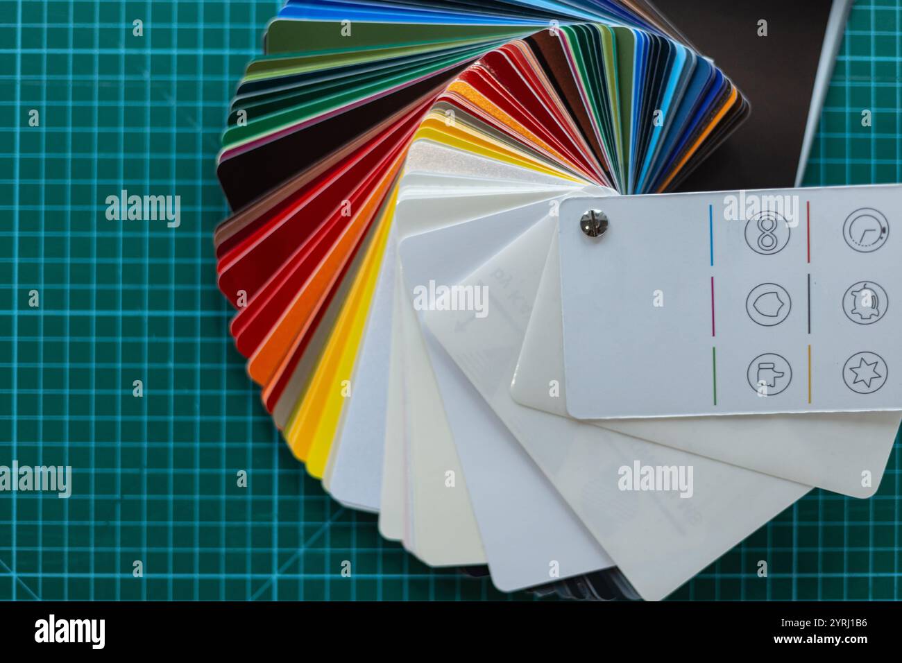 Set of car protective film color samples on green work table with grid ...