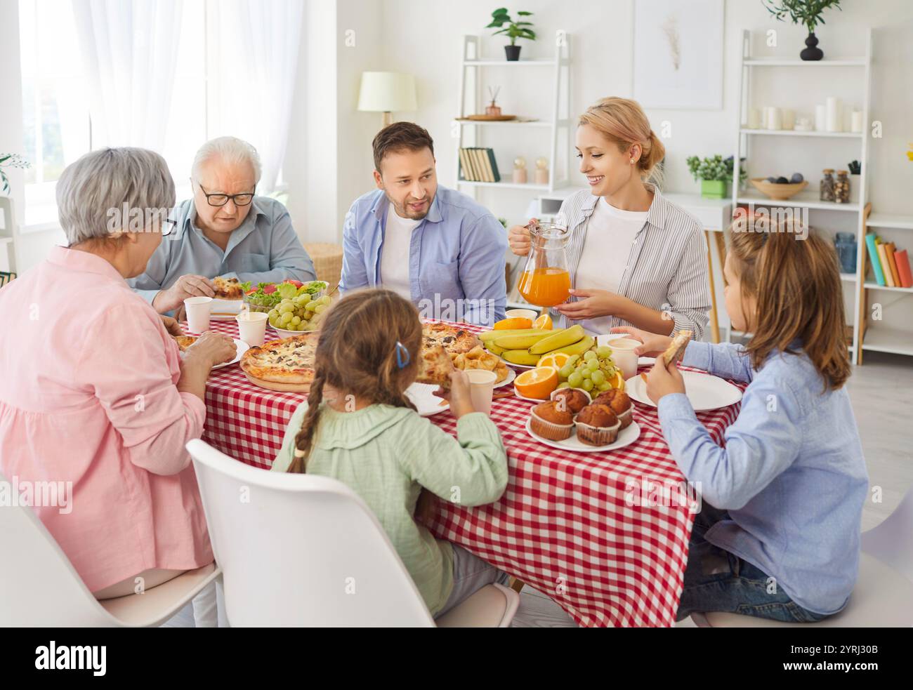 Happy family union meal at home, grandparents, mother, father with two ...