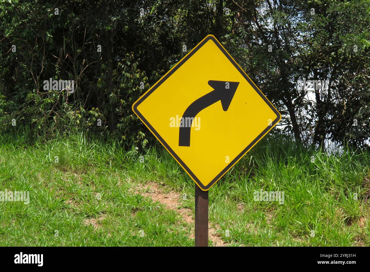 right turn symbol sign - yellow sign sharp curve sign on highway Stock ...