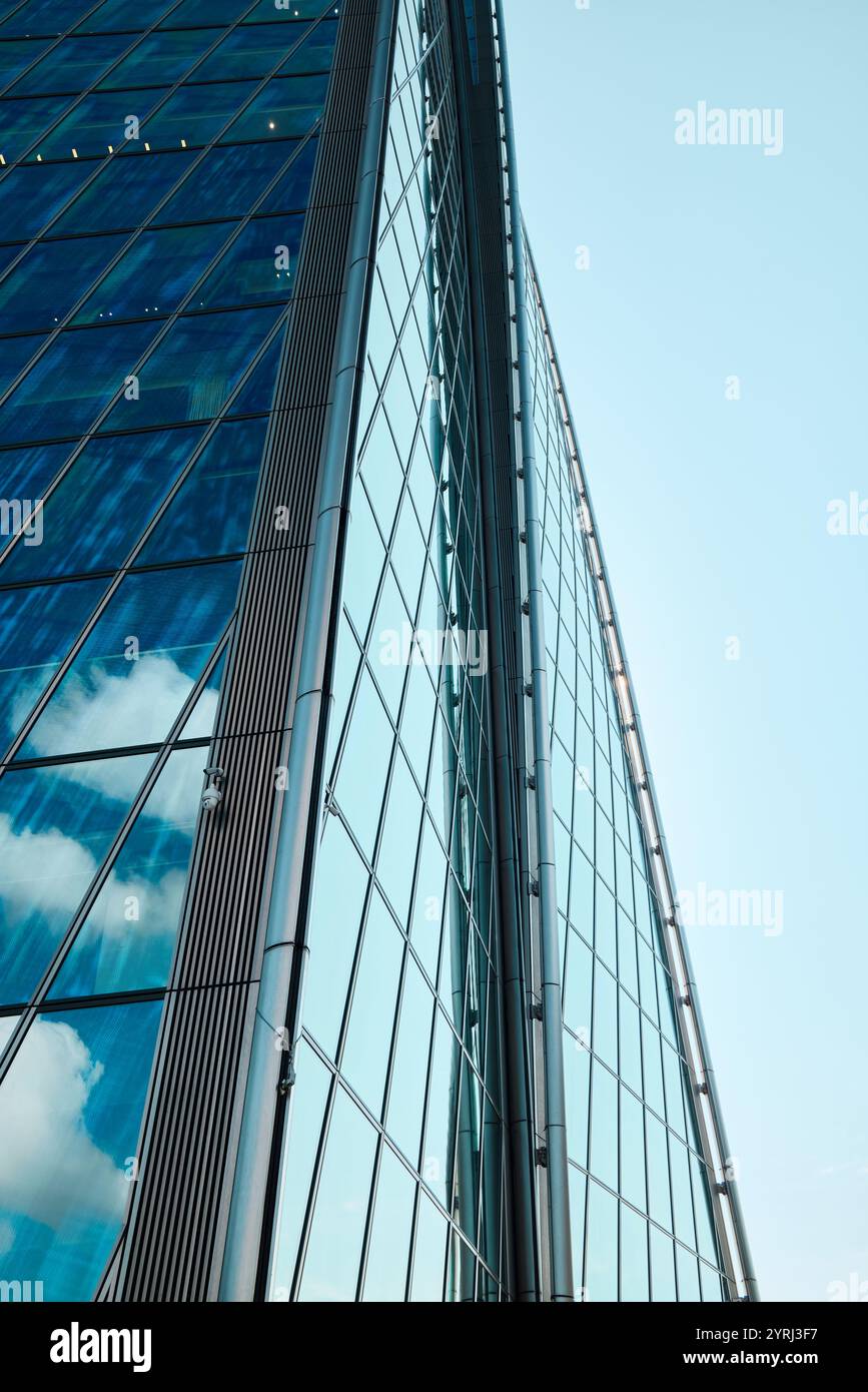 A Modern Skyscraper is Reflecting the Beautiful Blue Sky and Fluffy ...