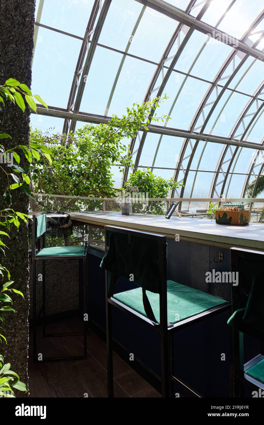 A modern indoor cafe featuring beautiful greenery and a stunning ...