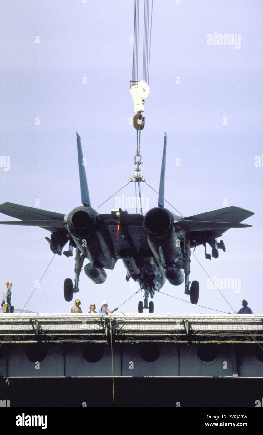 A Fighter Squadron 211 (VF-211) F-14A Tomcat aircraft is lowered by ...