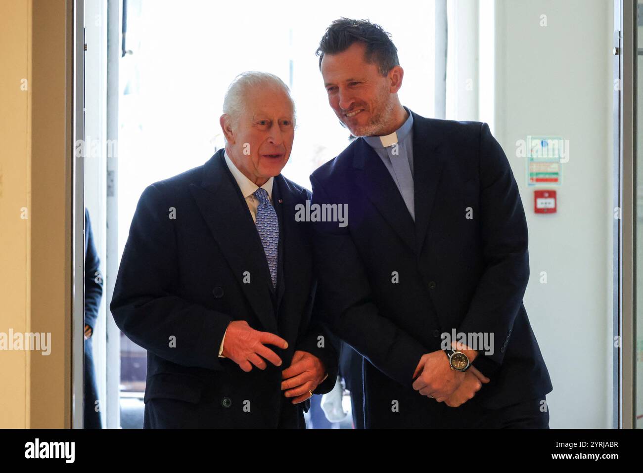 King Charles III walks with Reverend Pat Allerton during a visit to St ...