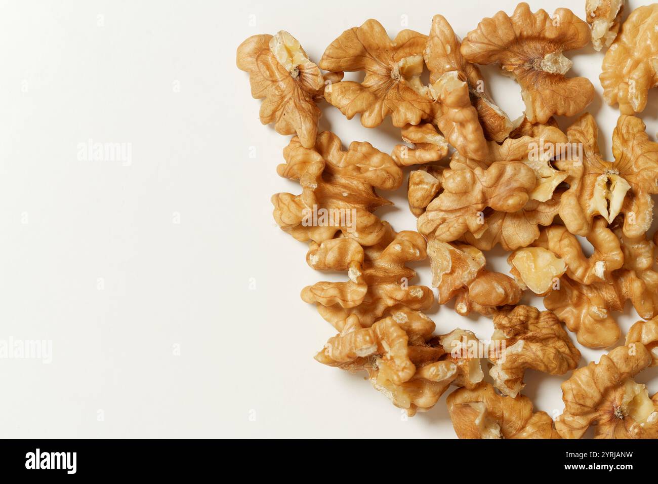 shelled walnuts lying on white background Stock Photo - Alamy
