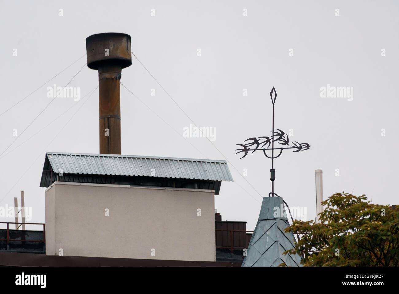 Urban Rooftop with Weather Vane and Industrial Chimney Stock Photo - Alamy
