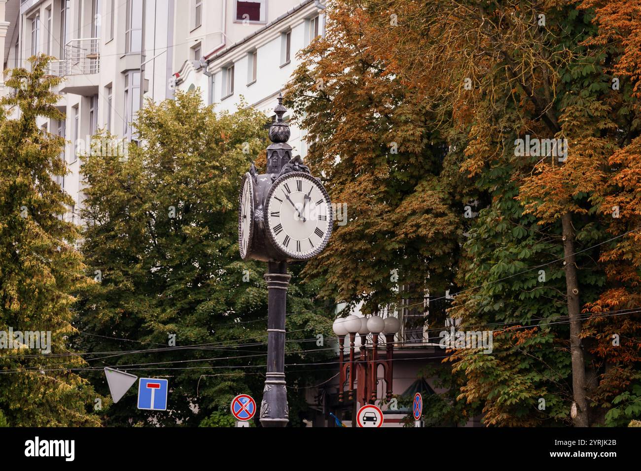 Vintage Clock Tower Amidst Autumn Foliage in Urban Setting Stock Photo ...