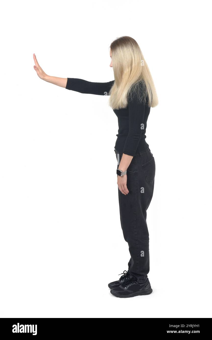 side view of a woman showing the stop sign with their hands on white ...