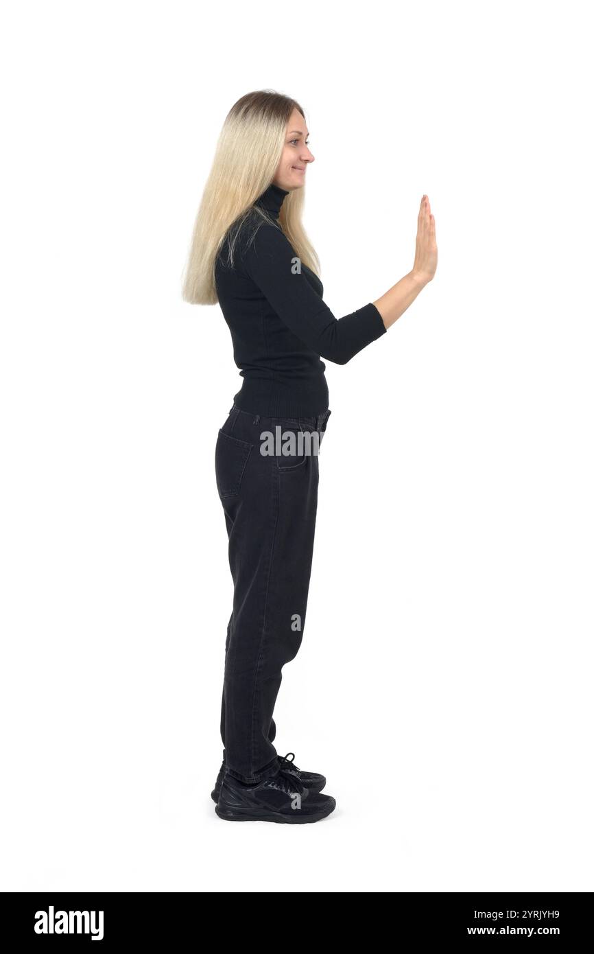 side view of a woman showing the stop sign with their hands on white ...