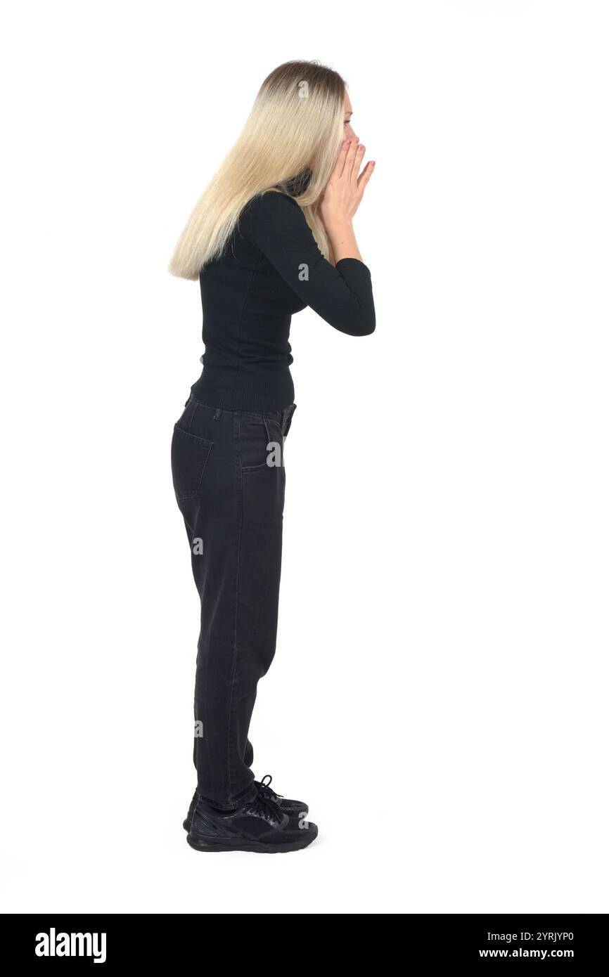 side view of a standing woman who is screaming on white background ...