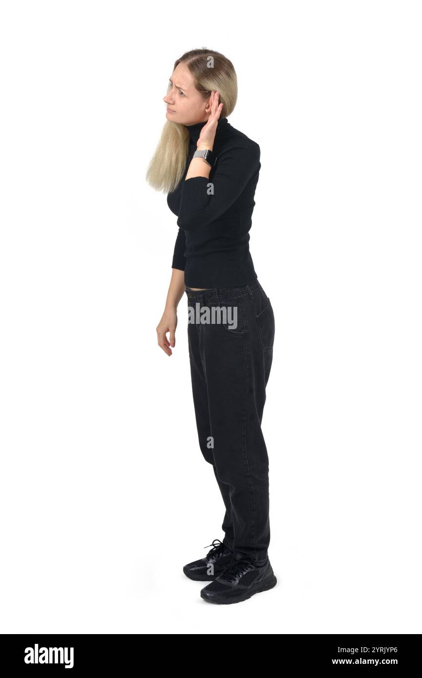 side view of a woman with hand on ear who is listening on white ...