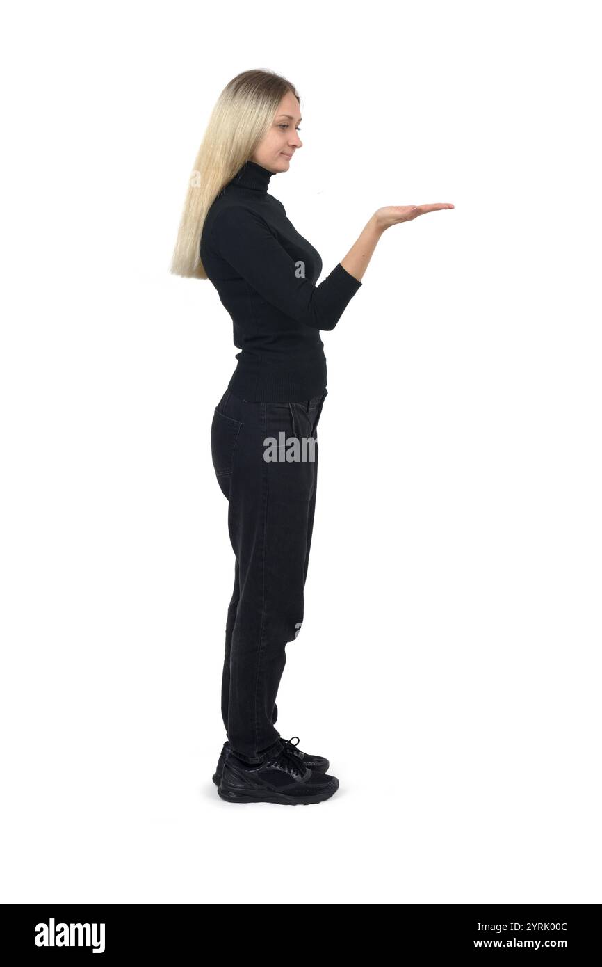 side view of a woman showing an imaginary object in her hand and ...