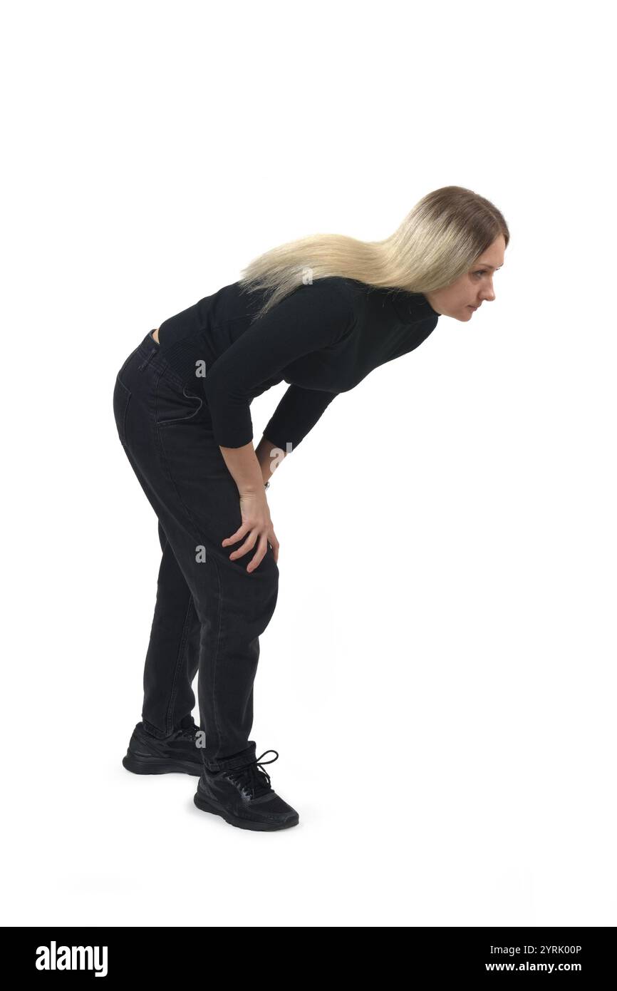 side view of a woman crouching and looking away on white background ...