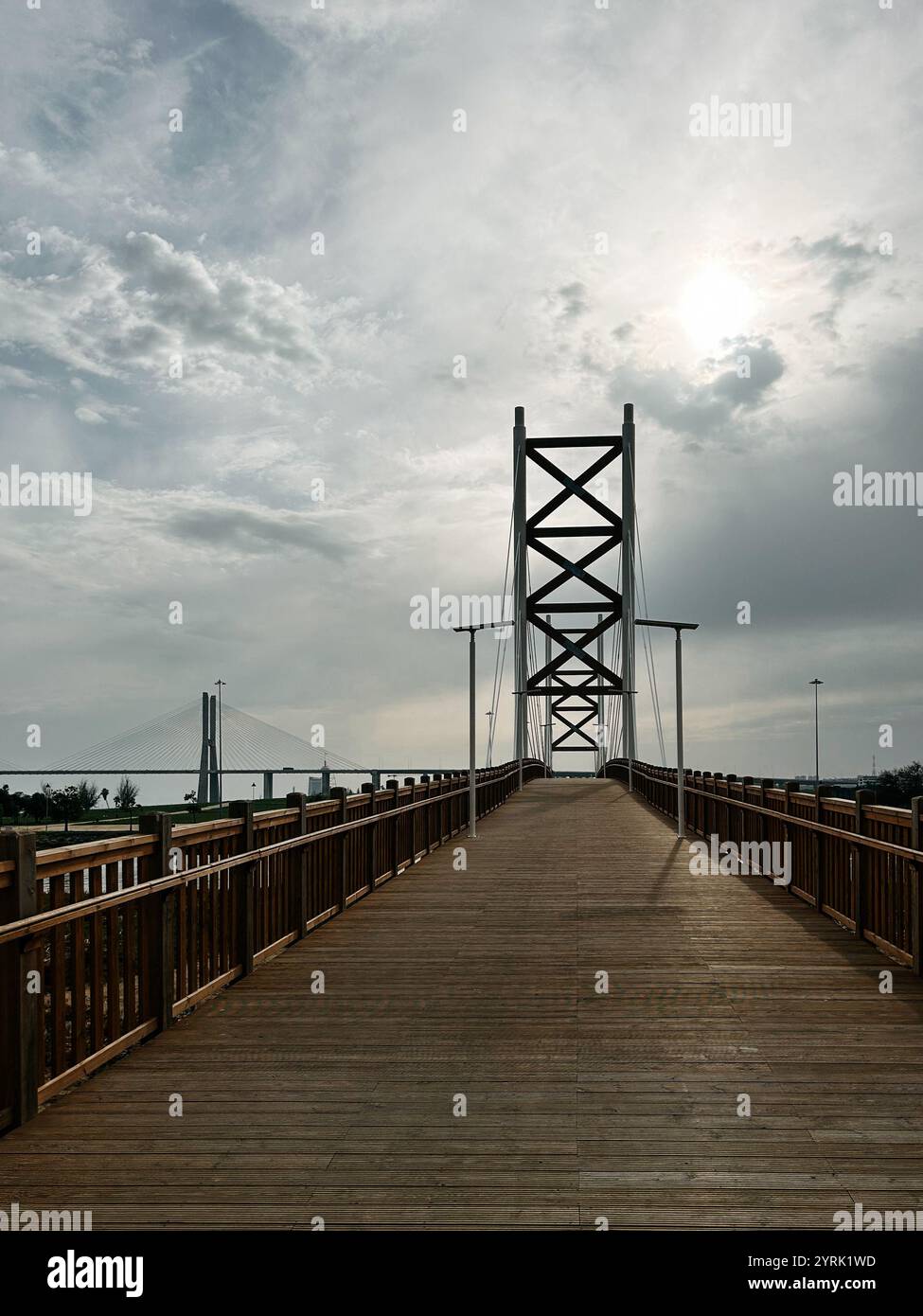 A wooden pedestrian suspension bridge with metal supports and geometric ...