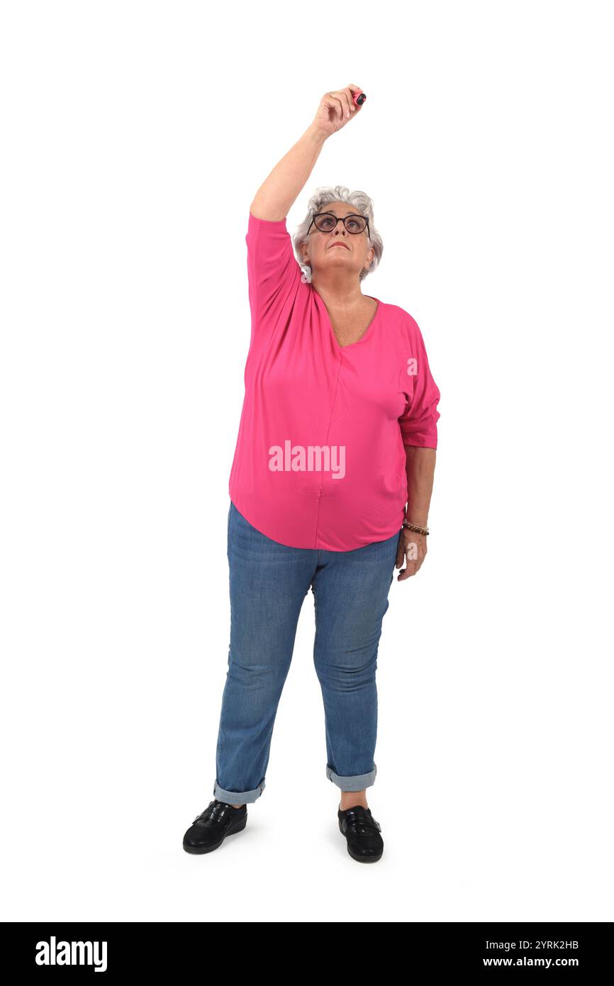 front view of senior woman drawing with marker with raised arm on white ...