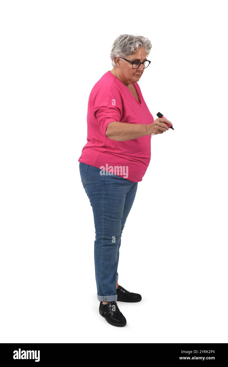 side view of a crouching woman drawing with a marker on white ...