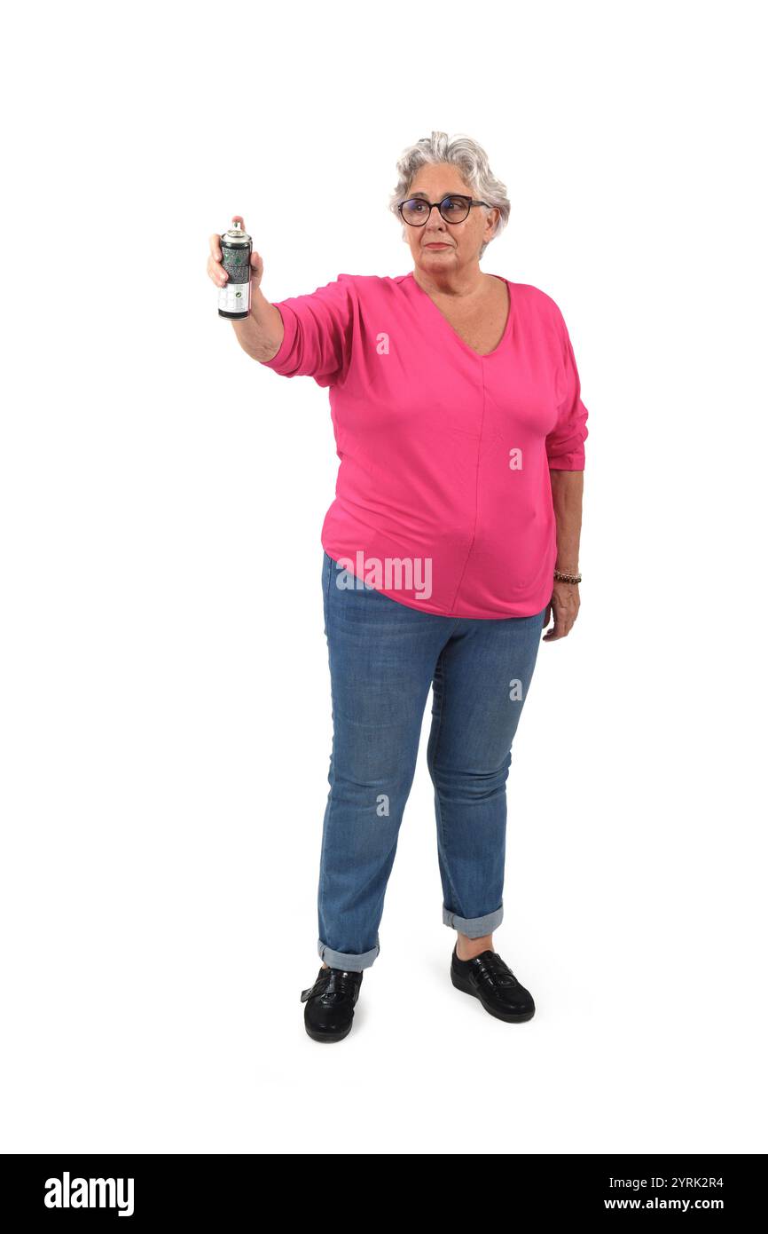 front view of a senior woman spray painting on white background Stock ...