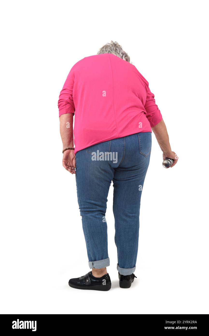 back view of crouched senior woman painting with spray on white ...