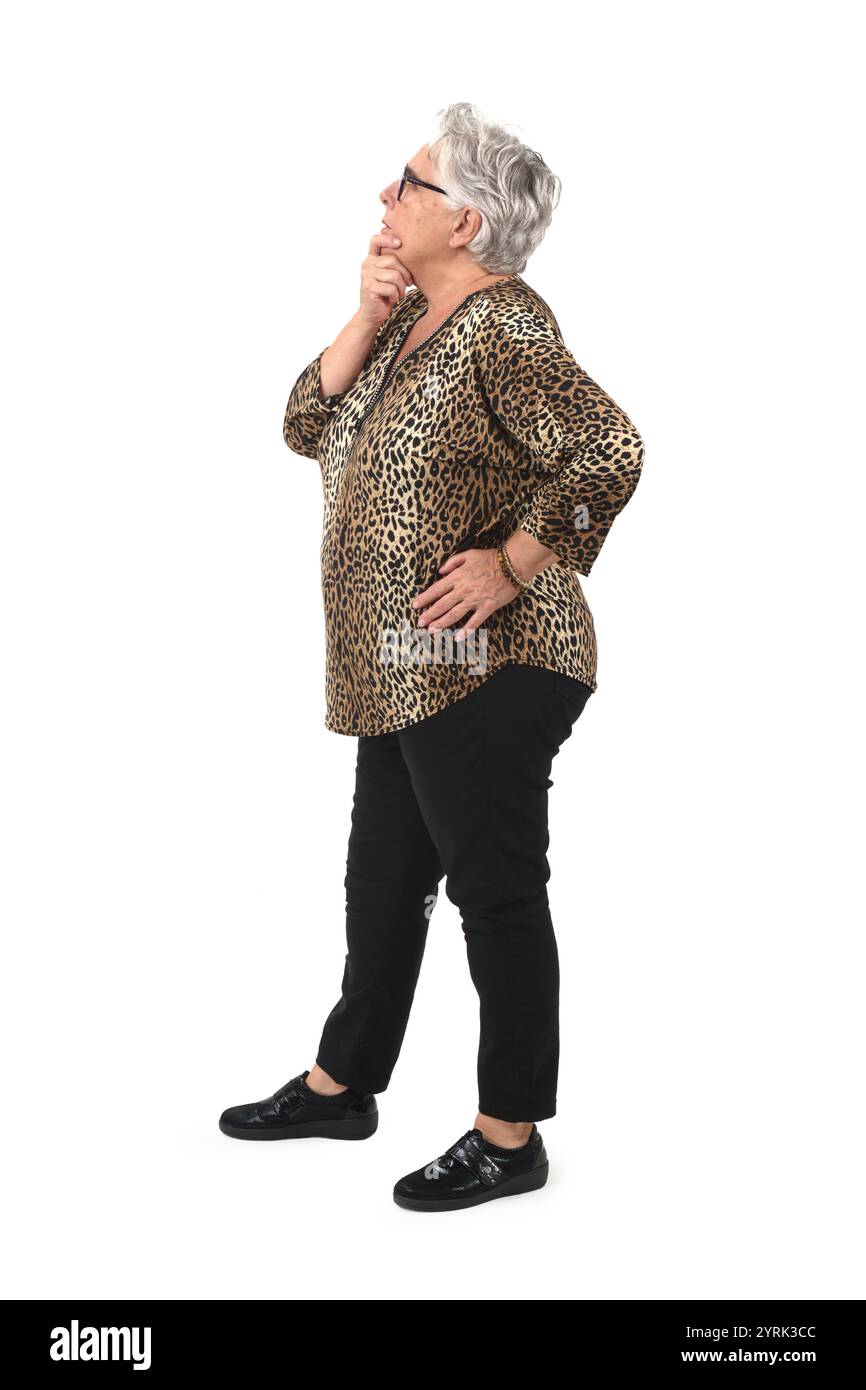 side view of a senior woman thinking with han on chin and look up on ...