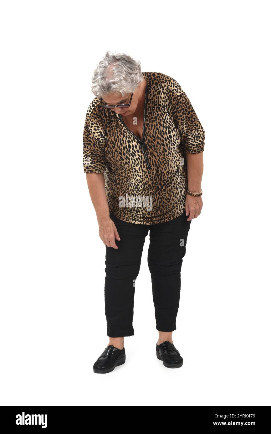 front view of a crouching senior woman searching for something ...