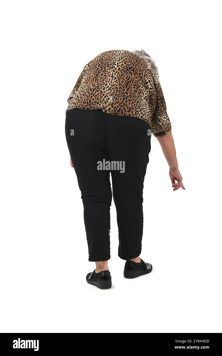 back view of a crouching senior woman pointing with finger on the ...