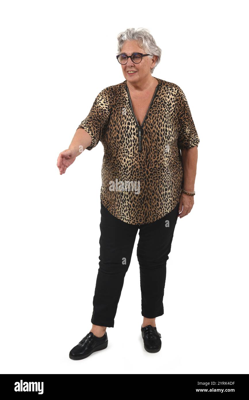 front view of a senior woman shaking hands with imaginary person on ...