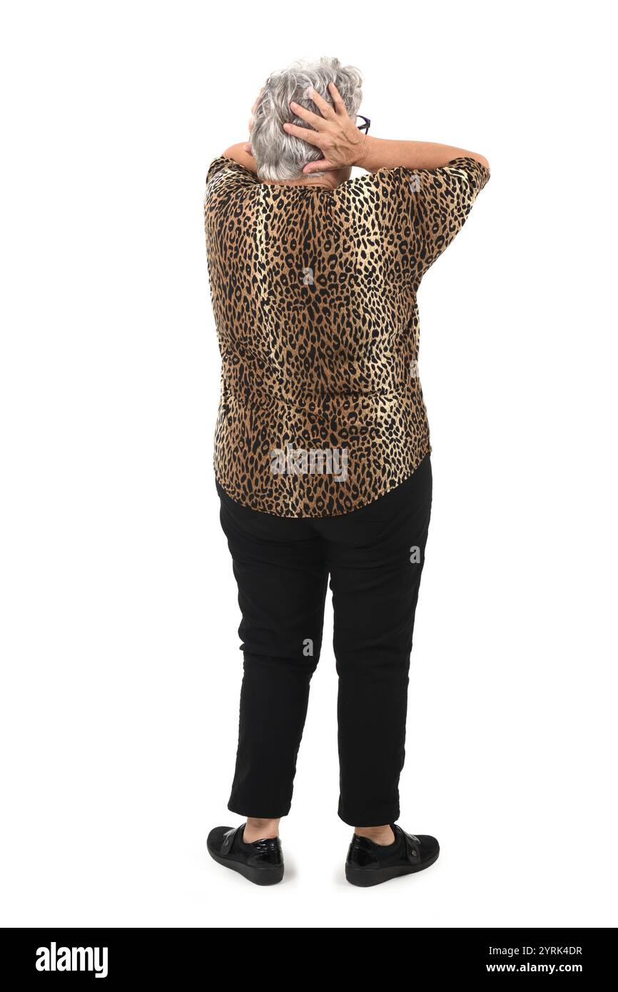 back view of senior woman covering her ears from noise on white ...