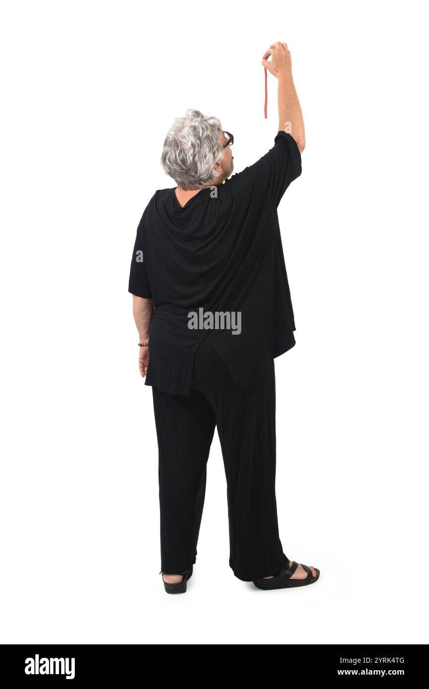 back view of a senior woman eating a licorice on white background Stock ...