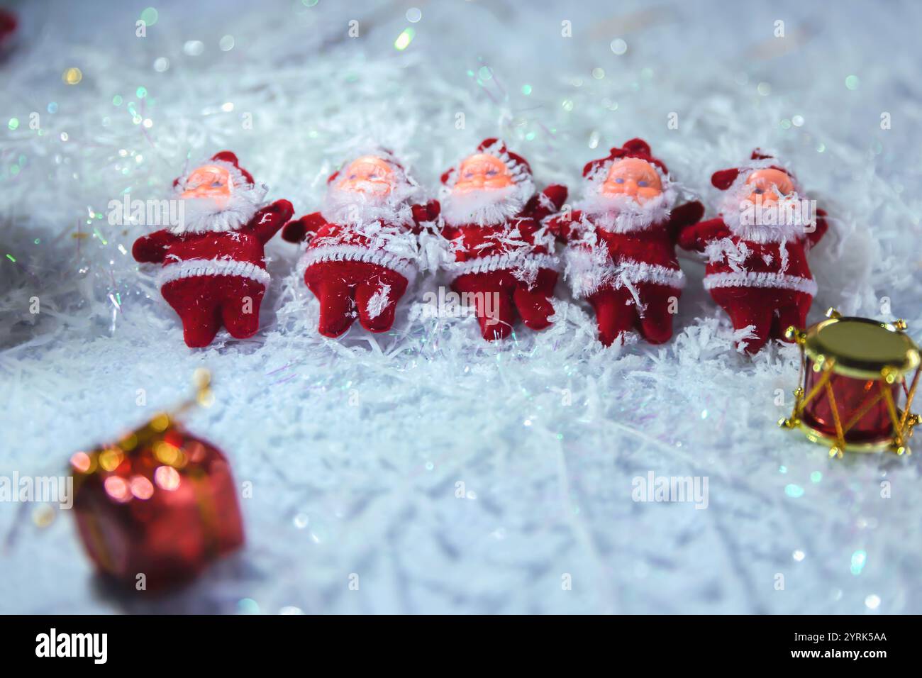 Miniature Santa Claus on a snowy background with golden elements ...