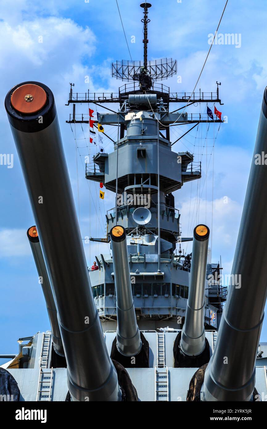 A large battleship with four huge guns on the front. The ship is ...