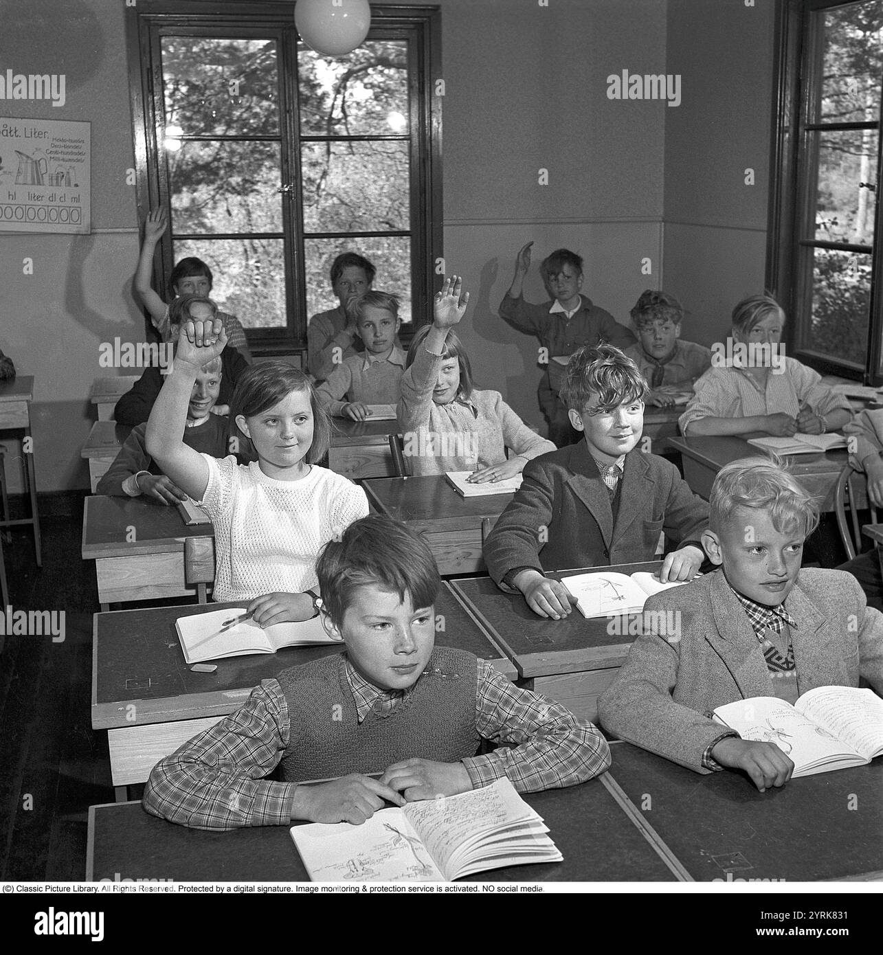 A classroom in 1952. Interior of a classroom where a class is sitting ...