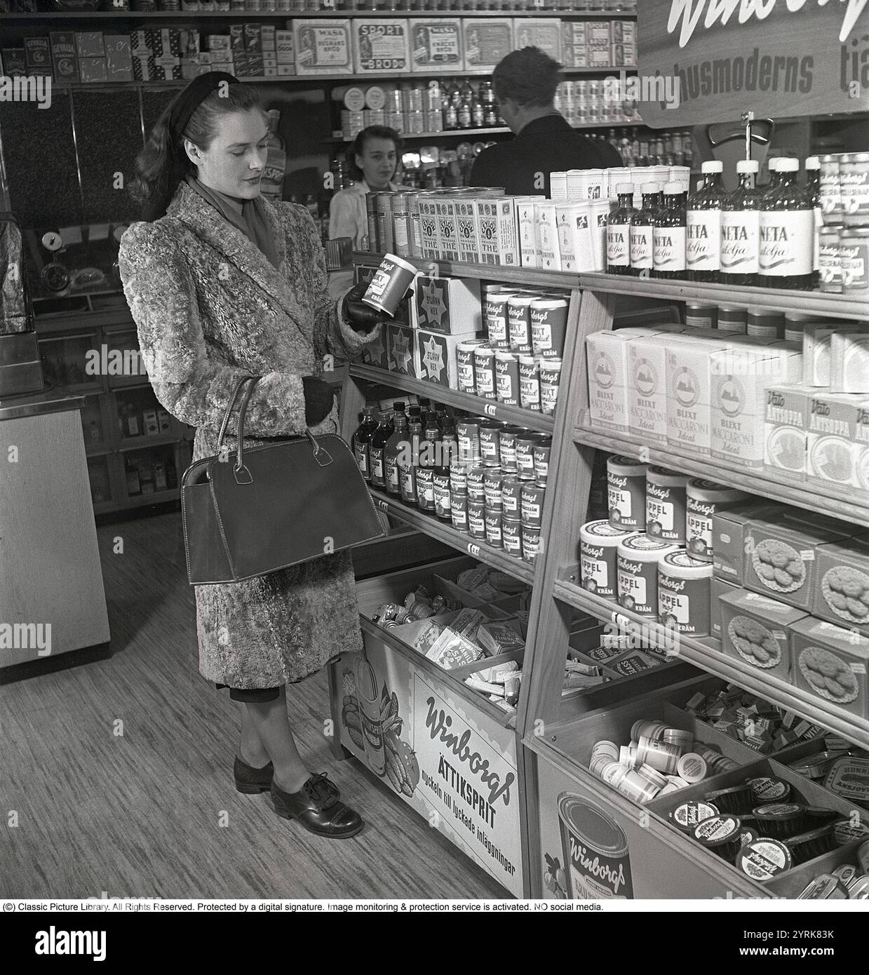 A woman shopping for food in the 1940s. A young woman is shopping in a ...