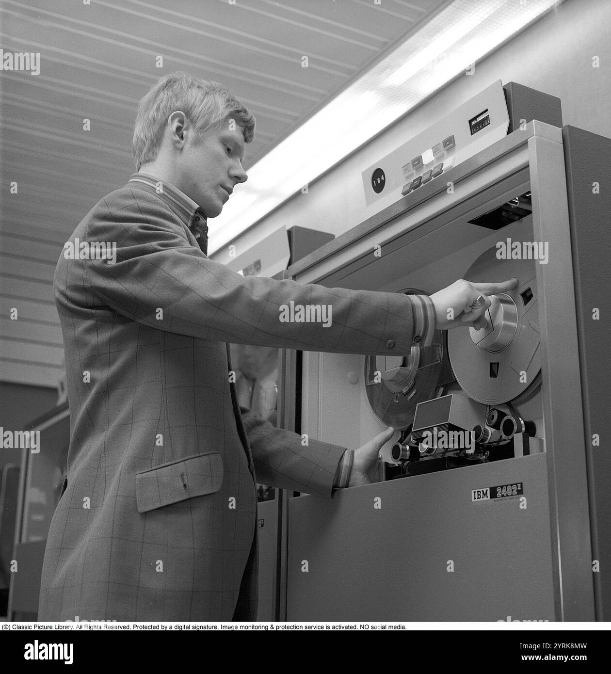 In the 1960s. Interior of a room with computers and people on the job ...