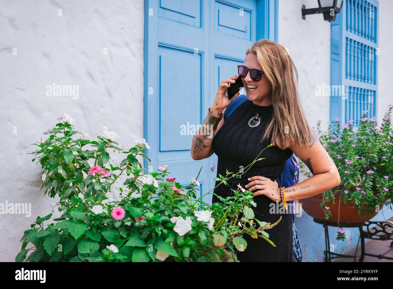 A joyful middle-aged woman with straight hair and a curvy Latin figure ...