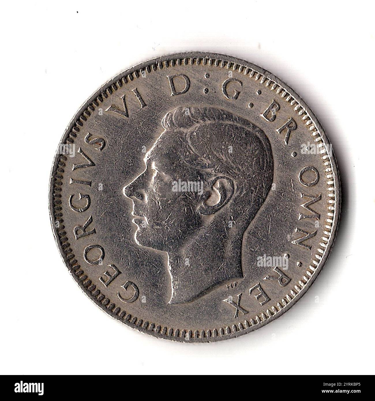 The front of a King George VI shilling from Great Britain on a white ...