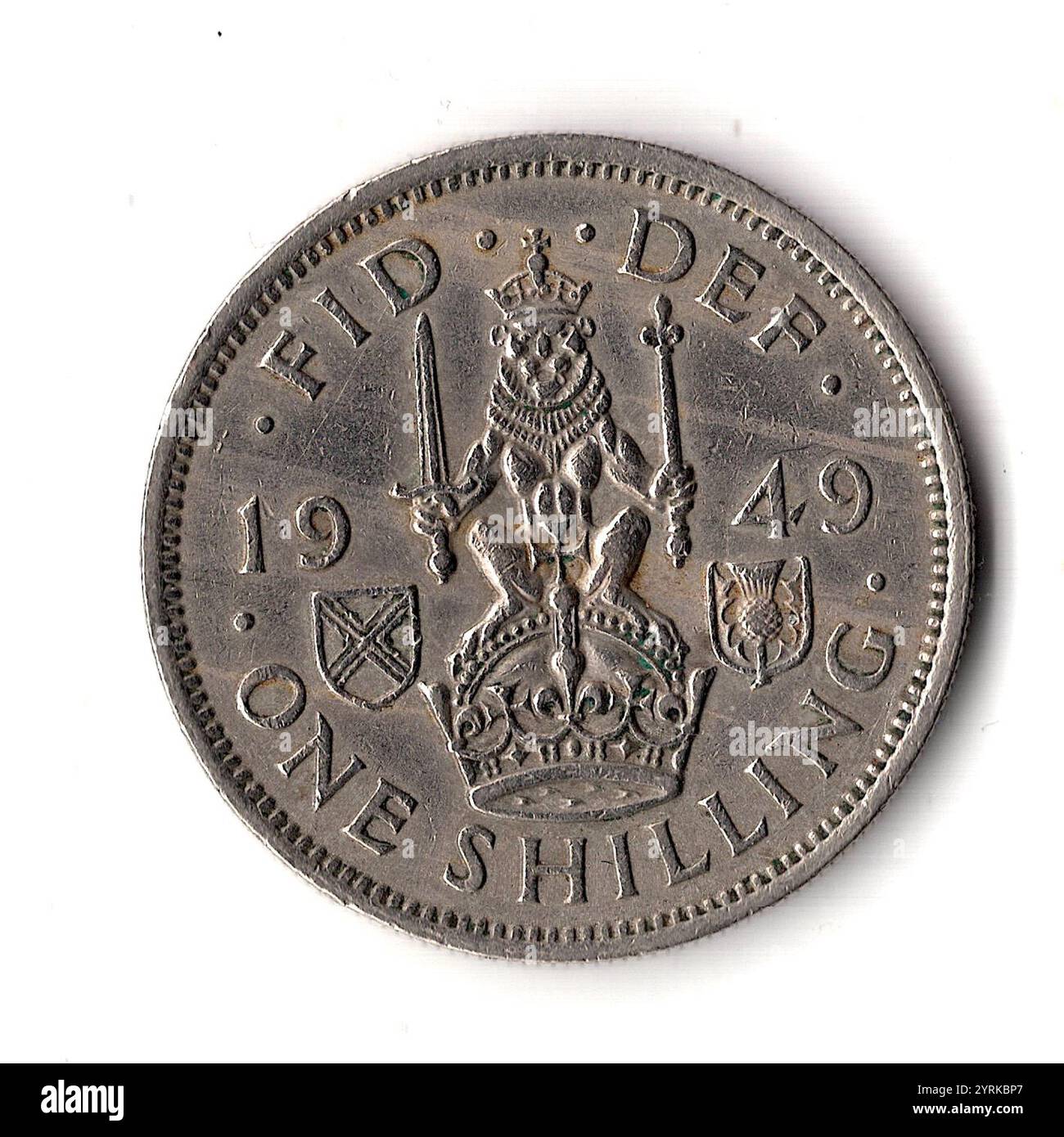 The back of a King George VI shilling from Great Britain on a white ...