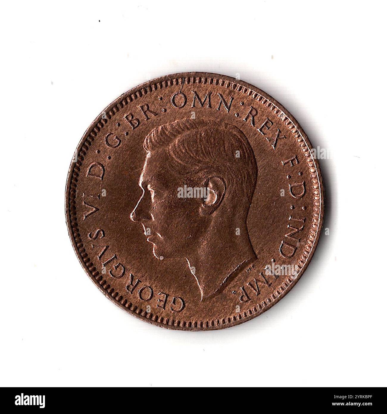 The front of a King George VI farthing from Great Britain on a white ...