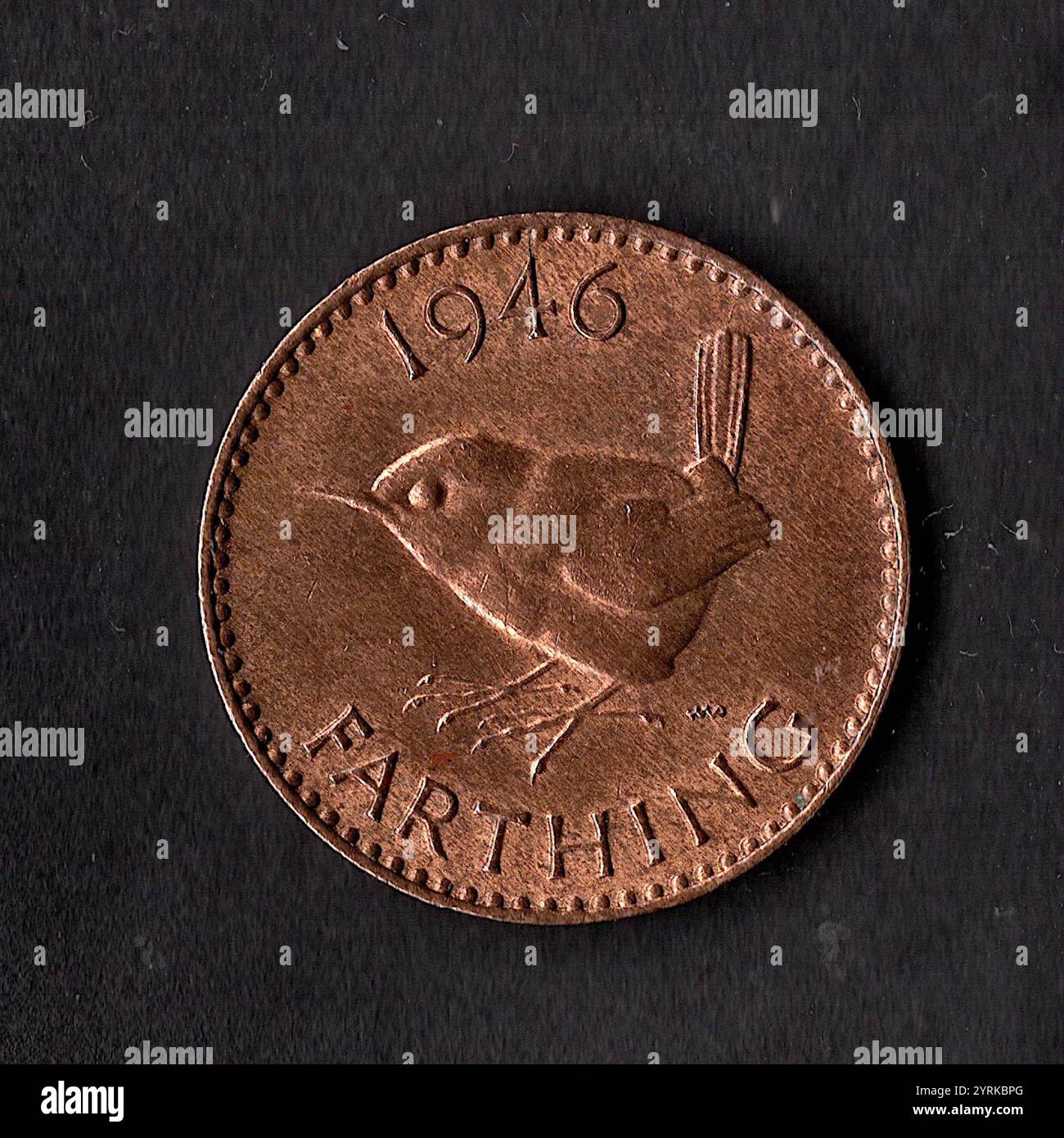 The back of a King George VI farthing from Great Britain on a black ...