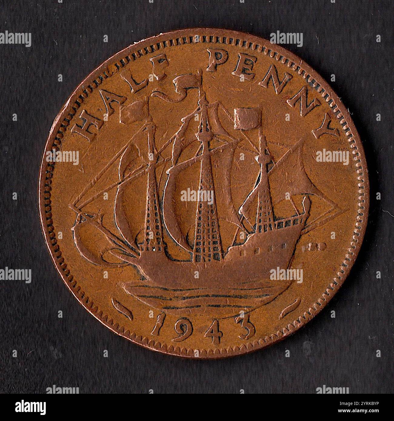 The back of a King George VI half penny from Great Britain on a black ...