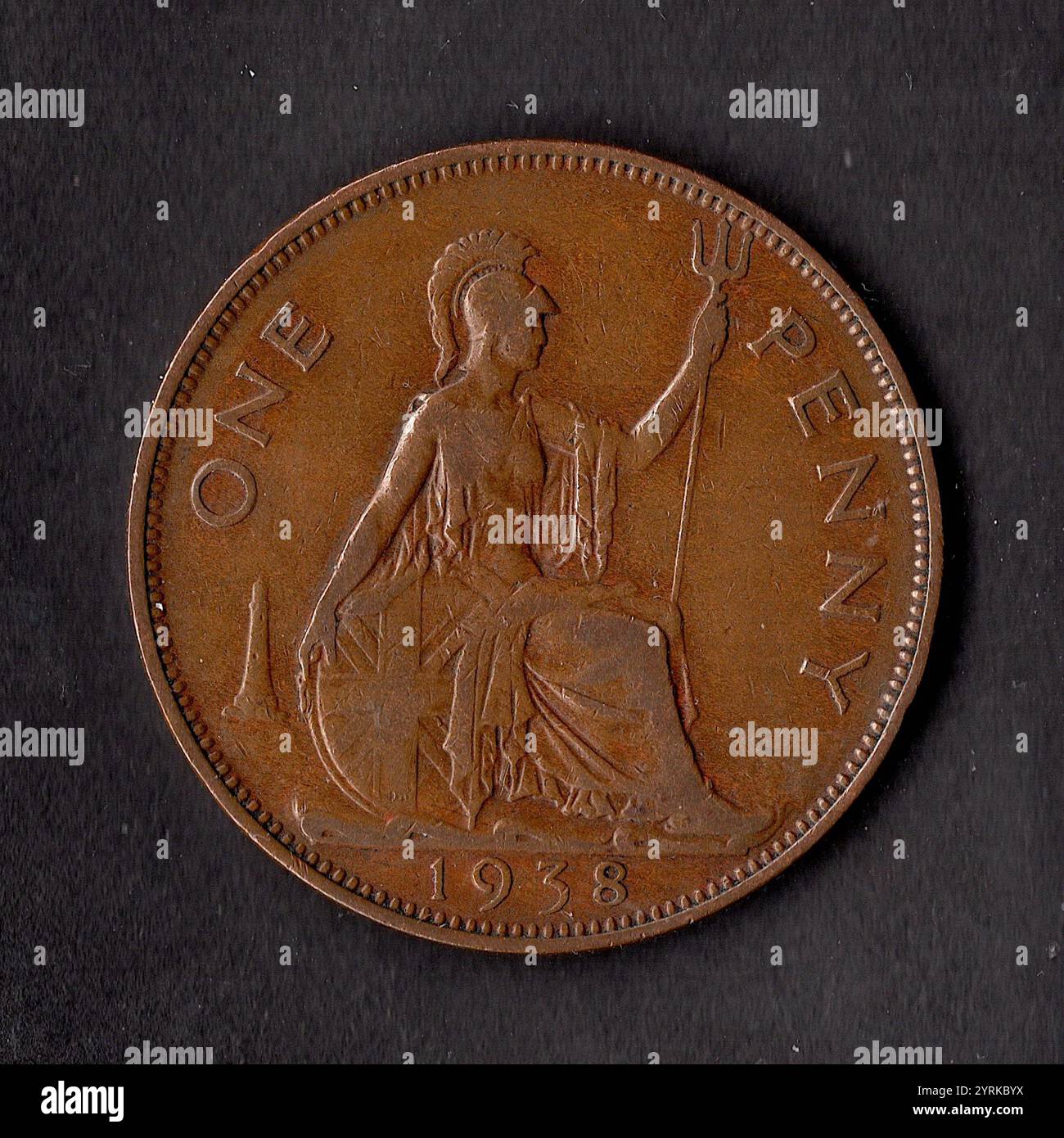The back of a King George VI penny from Great Britain on a black ...