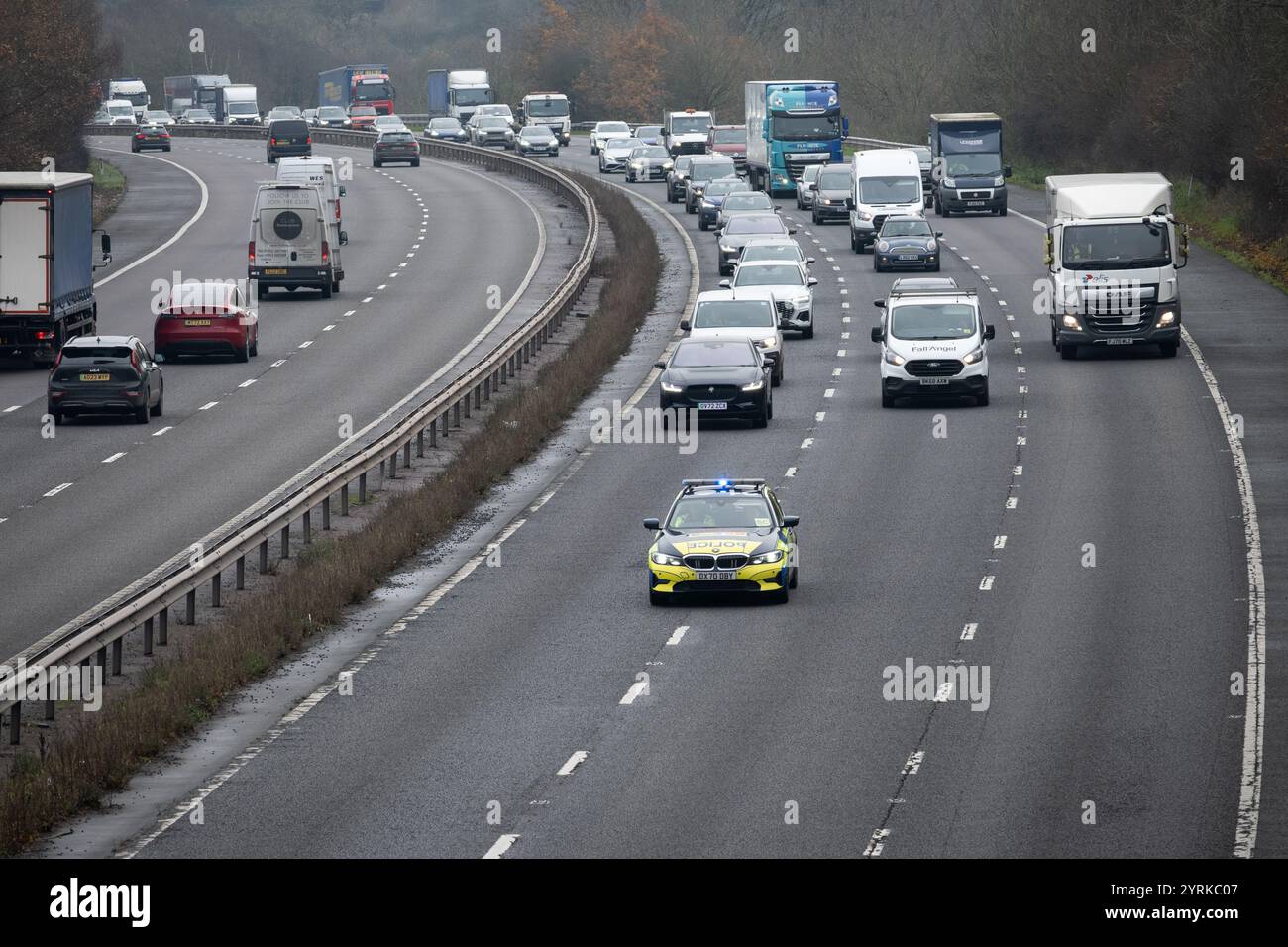 A police car lead escorting traffic on the M40 motorway, Warwickshire ...