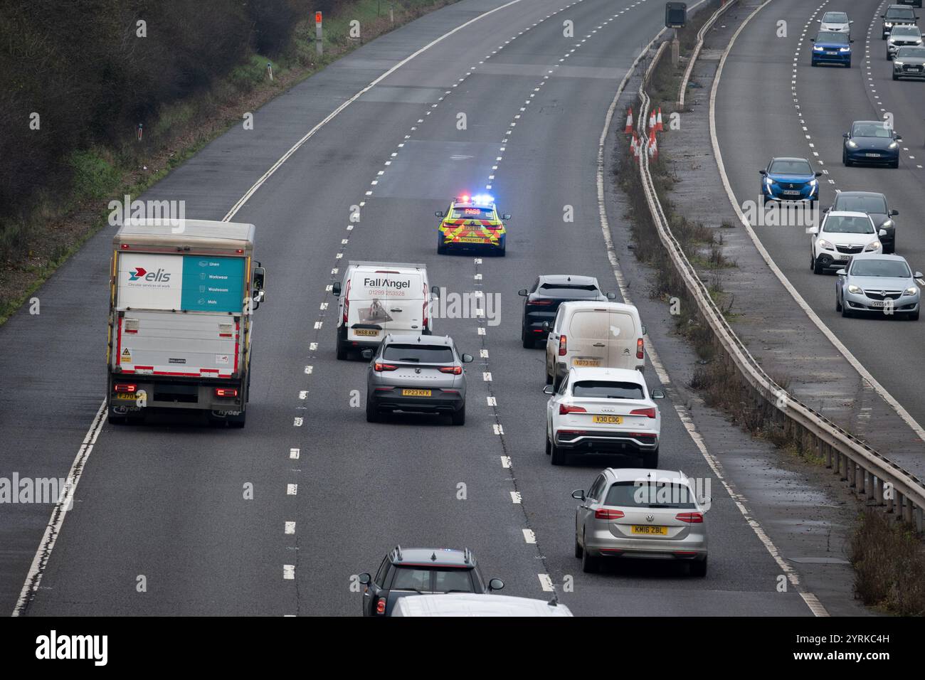 A police car lead escorting traffic on the M40 motorway, Warwickshire ...
