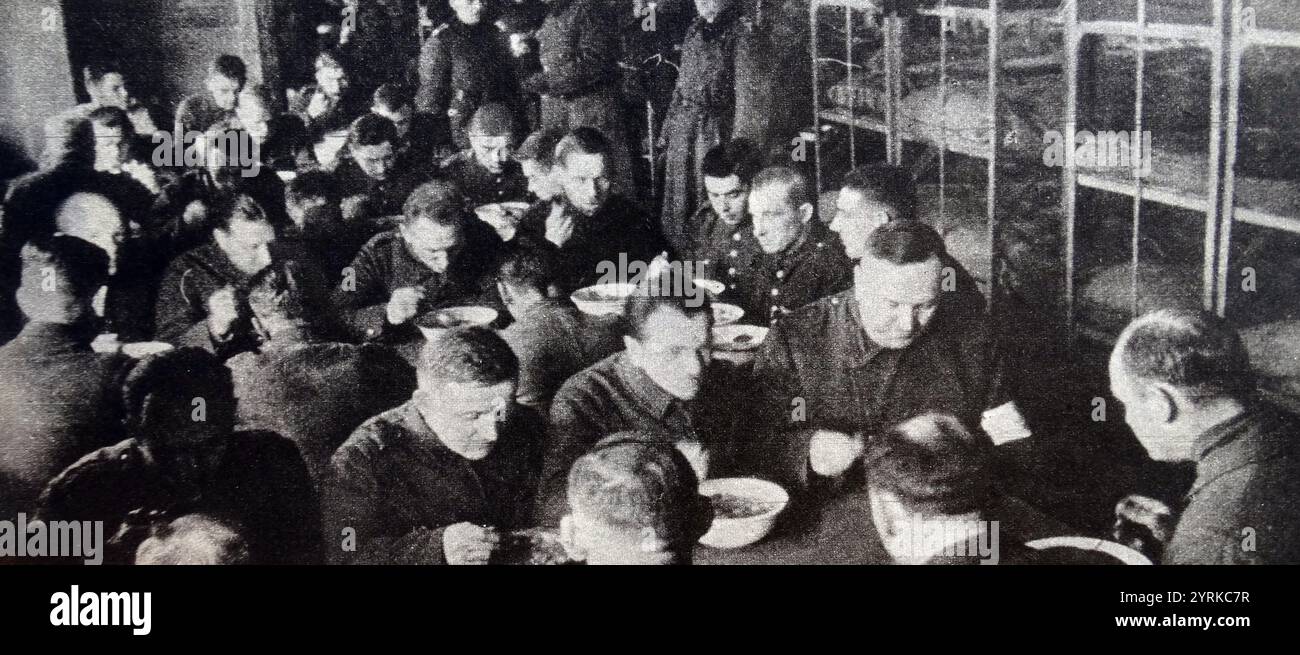 Prisoners are served meals in a German prisoner of war camp during ...