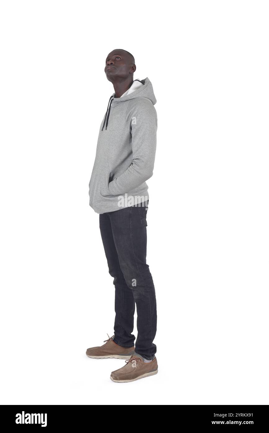 side view portrait of a man standing and look up on white background ...