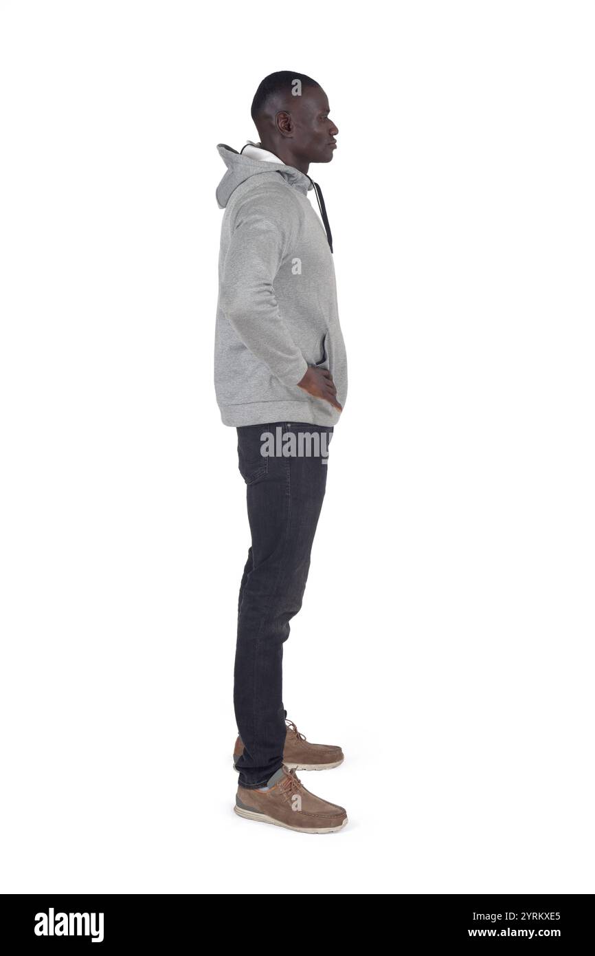 side view portrait of a man standing with arms akimbo on white ...