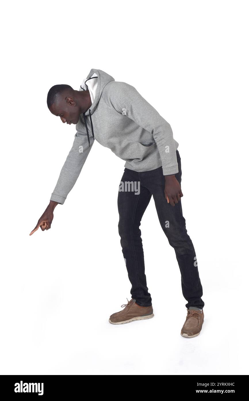 side view of a man pointing down on white background Stock Photo - Alamy