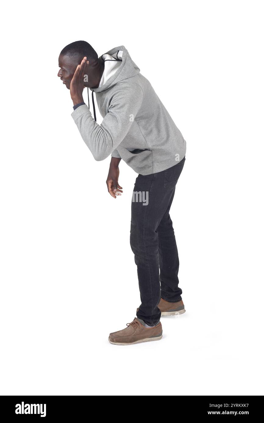 side view of a man with hand on ear who is listening on white ...