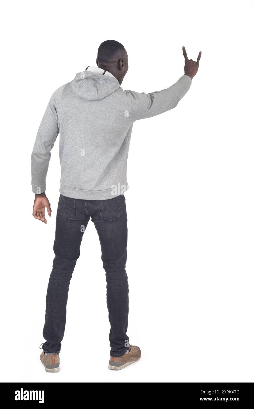 back view of a man showing the horns sign with fingers on white ...