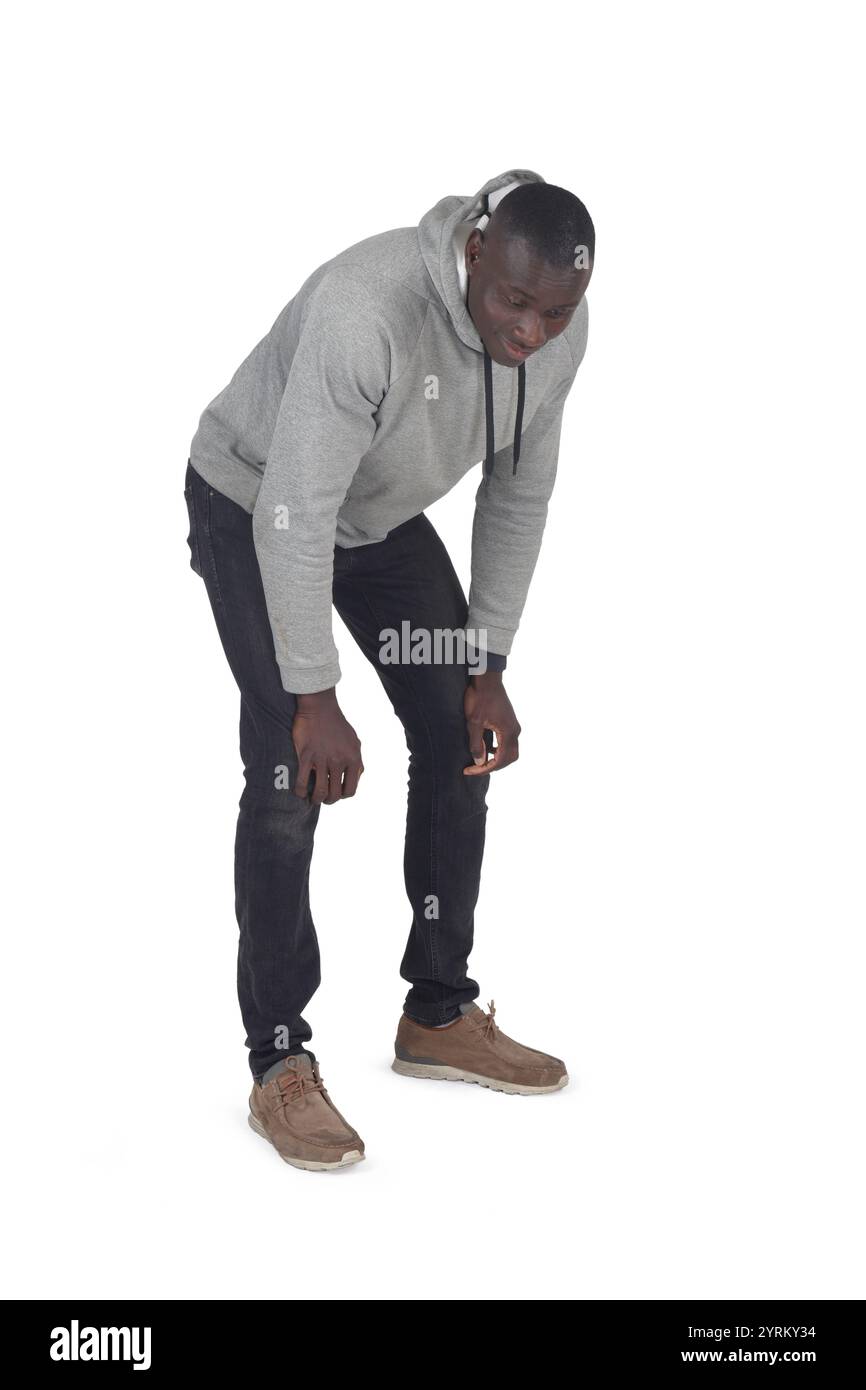 side view of a man crouched down and looking the floor on white ...