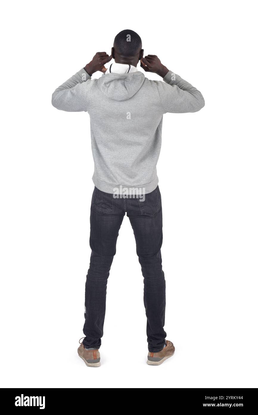 back view of a man covering her ears from noise on white background ...