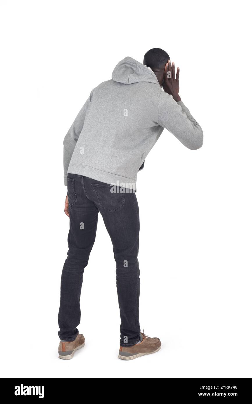 back view a man with hand on ear who is listening on white background ...